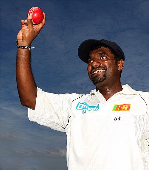 Muttiah Muralitharan holds up the ball with which he took his 709th ...