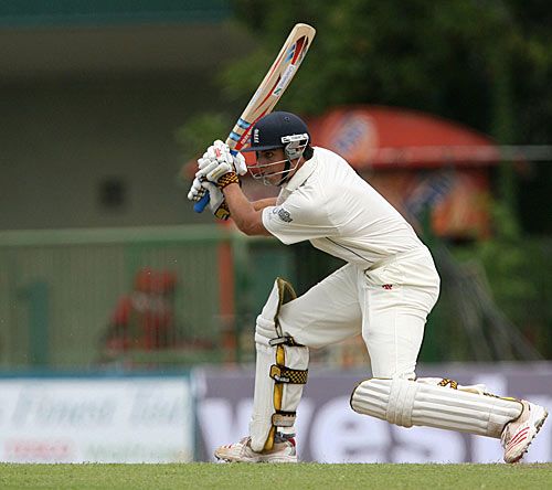 Alastair Cook comes forward to drive through the off side ...