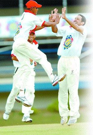 Lendl Simmons leaps high to celebrate the wicket of Sewnarine ...