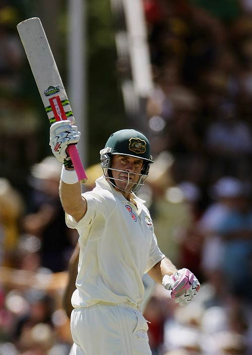 Matthew Hayden raises his bat after reaching his half-century ...
