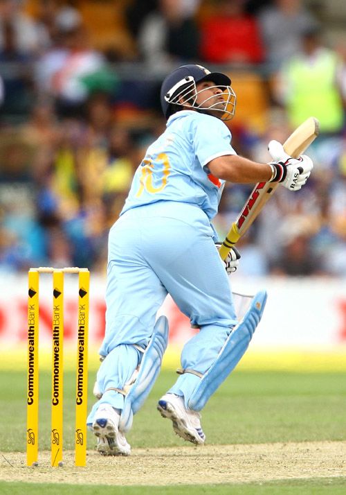 Sachin Tendulkar follows the course of the ball after playing a shot in ...