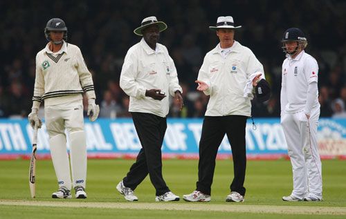 The umpires offer the light to New Zealand during the second session ...