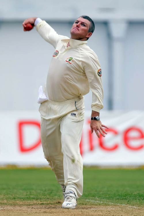 Stuart MacGill sends down a delivery | ESPNcricinfo.com