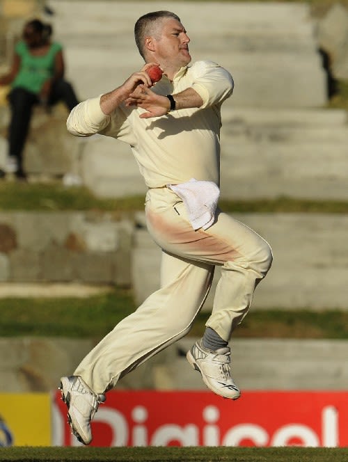 Stuart MacGill runs in to bowl | ESPNcricinfo.com