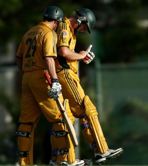 Cameron White assesses the damage after being struck on his hand while ...