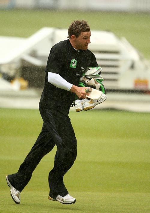 Brendon McCullum runs towards the dressing room in the rain ...
