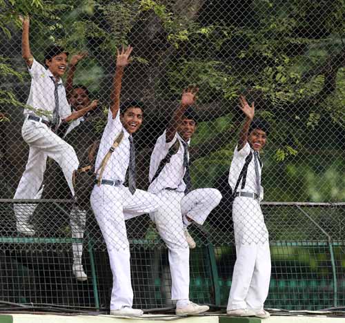 Schoolchildren catch a glimpse of the players training at the National ...