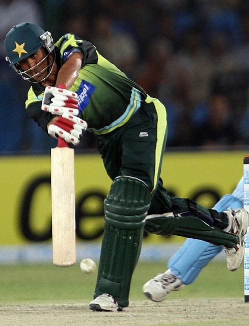 Younis Khan presents the full face of the bat as he drives ...