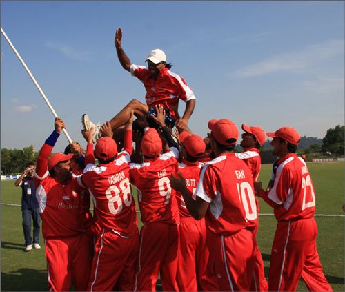 Hong Kong players celebrate their victory over Afghanistan by hoisting ...