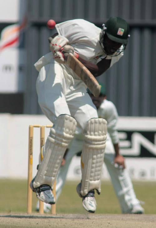 Trevor Garwe gets into a tangle while facing a rising delivery ...