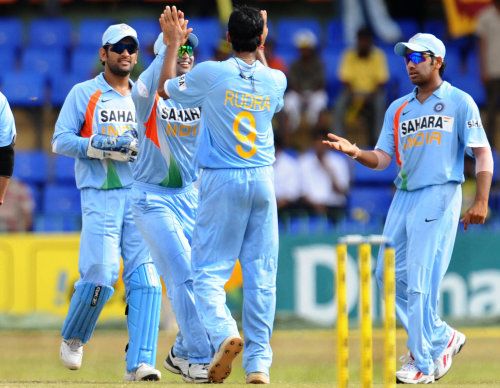 RP Singh converges with his team-mates after taking a wicket ...