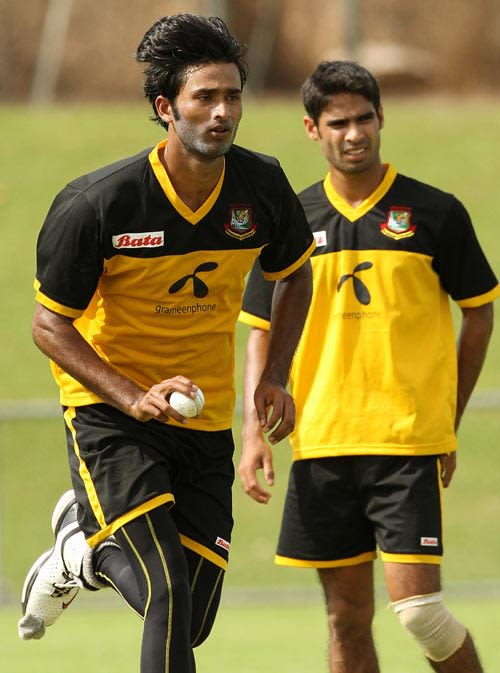 Farhad Reza looks on as Shahadat Hossain charges in during training ...