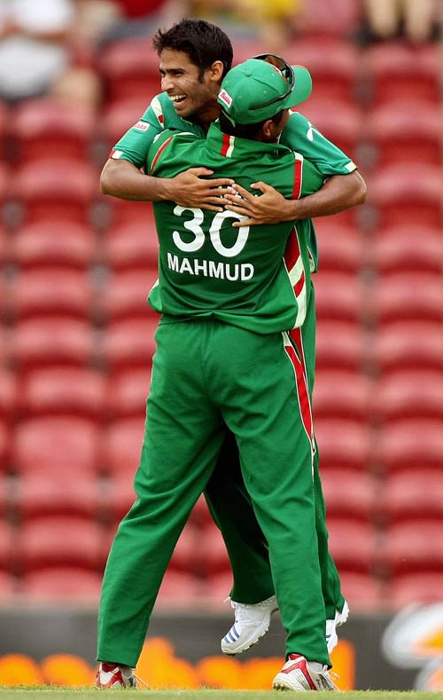 Farhad Reza is congatulated on picking up a wicket with his first ball ...