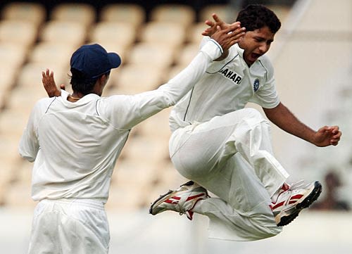 Piyush Chawla leaps in the air after bowling Ricky Ponting ...