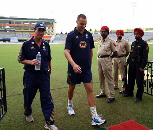 Stuart Clark and Andrew Hilditch head towards the indoor nets ...