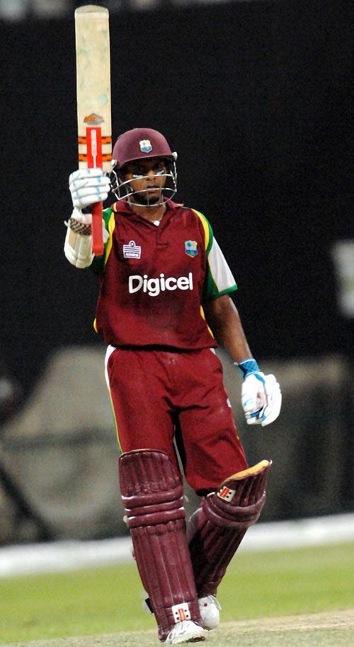 Shivnarine Chanderpaul raises his bat after reaching his century ...