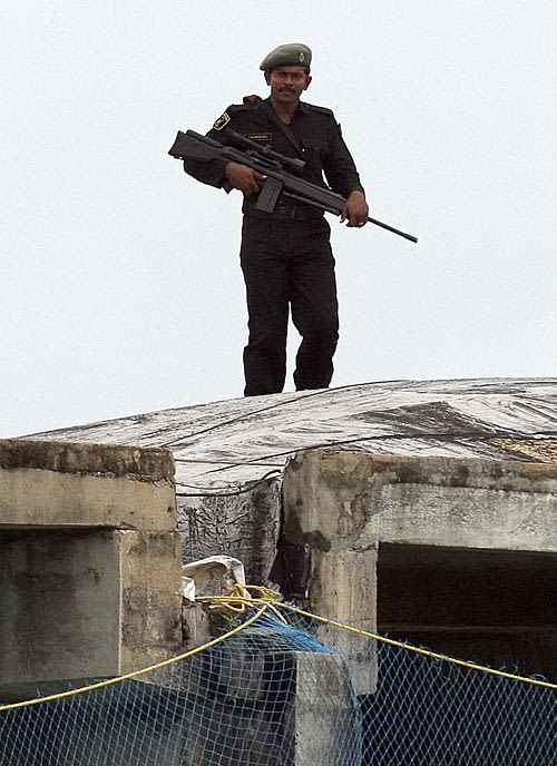 A sniper takes up position at the roof of the MA Chidambaram Stadium ...