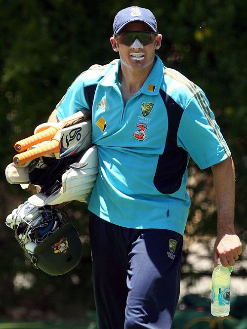 Michael Hussey walks with his kit towards the nets | ESPNcricinfo.com