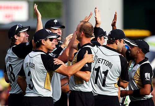Ewen Thompson is congratulated on his first international wicket ...