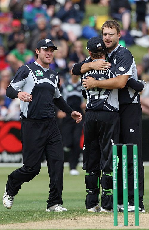 Jamie How and Brendon McCullum congratulate Daniel Vettori for taking ...