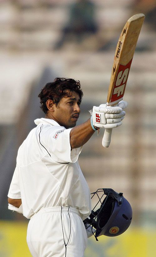 Tillakaratne Dilshan raises his bat after reaching his century ...