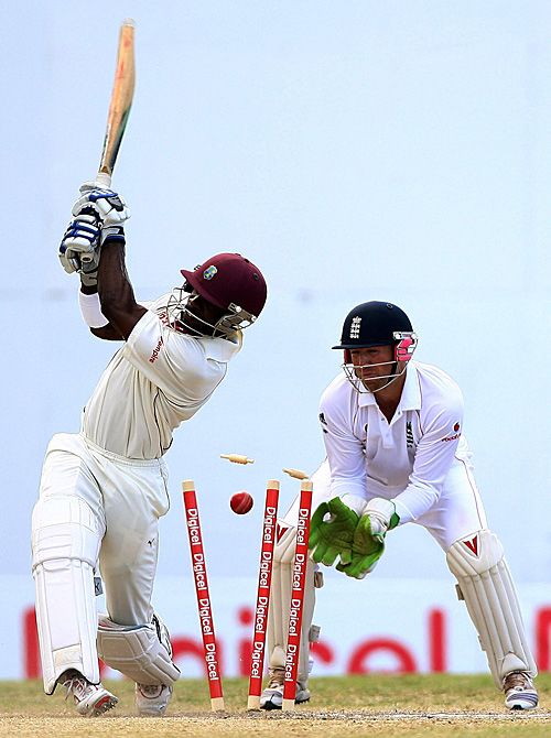 Devon Smith goes for a huge swing but is clean bowled by Graeme Swann ...