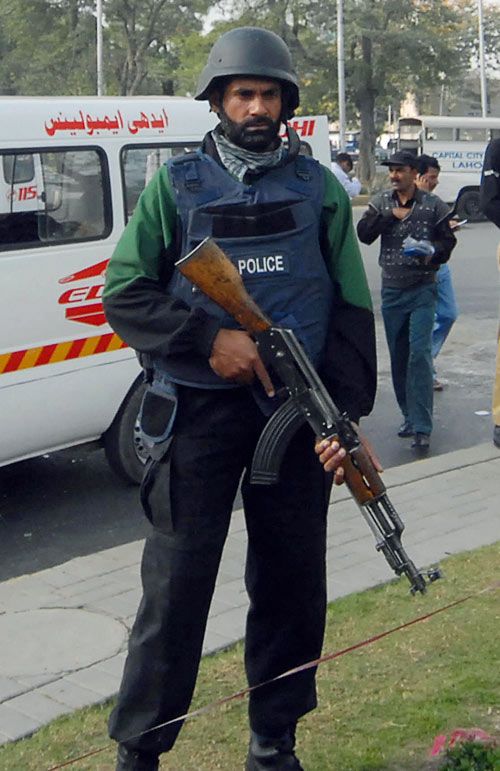 A security guard stands vigil after the firing in Lahore | ESPNcricinfo.com