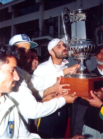 Moment of joy: Skipper Shahid Anwar plants a kiss on the trophy ...