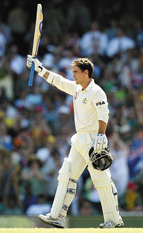 Justin Langer holds his bat aloft after a magnificent hundred ...