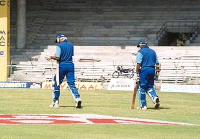 Openers Sriram and Ramesh walk on to the field in the final ...