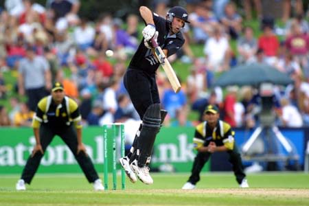 Fleming jumps to play a short rising ball down on the leg side ...