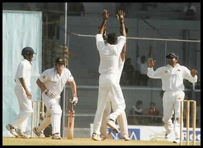 Kulkarni high-fives with Dighe after trapping Hayden in front ...