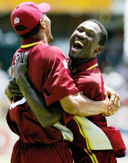 Mervyn Dillon is embraced by teammate Wavell Hinds after Dillon caught ...