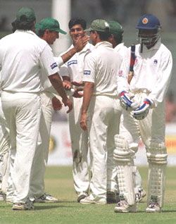 Debutant Irfan Fazil is congatulated after he picks up his first wicket ...