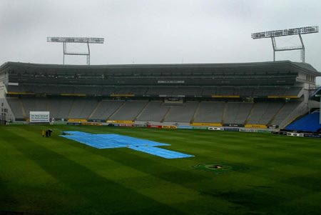 An empty ASB Bank Stand looks over the ground as rain prevents any play ...