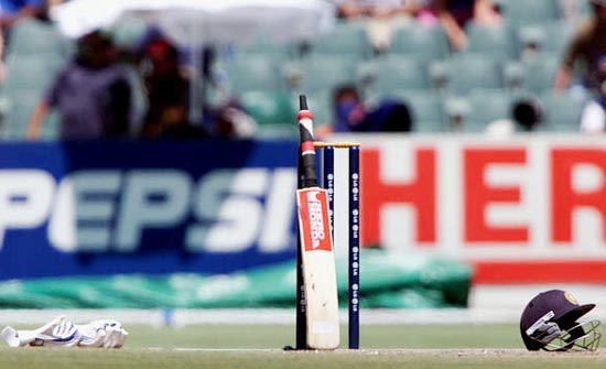 Ganguly's bat leans on the stumps during the drinks break ...