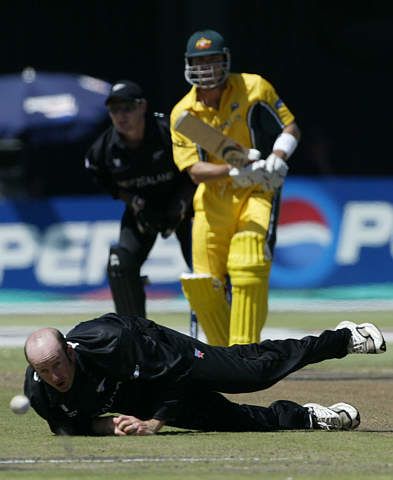 Martyn watches as Chris Harris dives to stop a straight drive ...