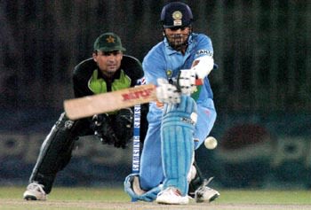 Indian star batsman Sachin Tendulkar sweeps a ball off Pakistani spin ...