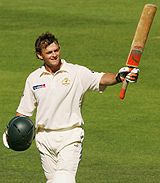 Adam Gilchrist raises his bat on reaching a century | ESPNcricinfo.com