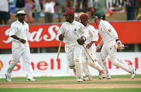 Ridley Jacobs makes off with the stumps at the end of the Windies ...