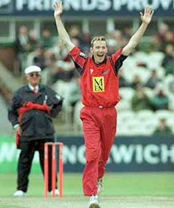 Schofield is all smiles after picking up the wicket of Geoff Cook ...