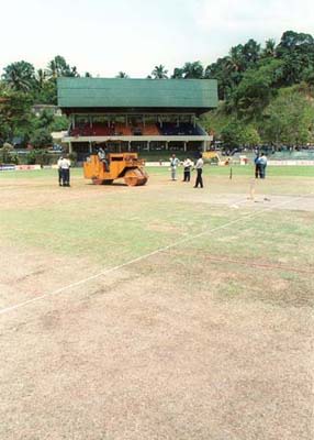 Ground staff try to make the rain affected ground playable ...