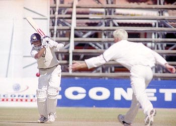 Dravid in full cry drives past the outstretched hand of Andy Blignaut ...