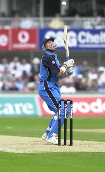 Alec Stewart sees the ball bouncing over his stumps to safety ...