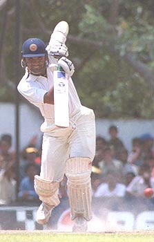 Atapattu plays a textbook straight drive back past the bowler ...