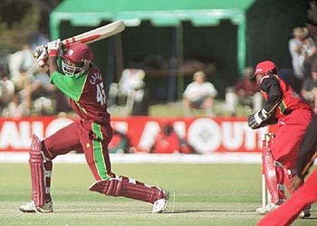 Gayle goes on the front foot to despatch the ball through covers ...