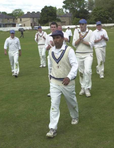 Mujtaba is applauded off by his colleagues after taking 9-61 ...