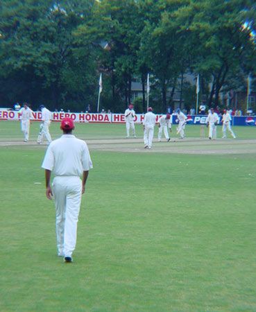 Seebaran walks in from the outfield as the ball is bowled ...