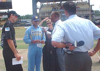 Match Referee Cammie Smith speaks to the captains before the toss ...