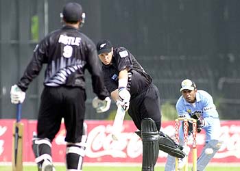 Adam Parore steps onto the front foot and turns one to leg ...